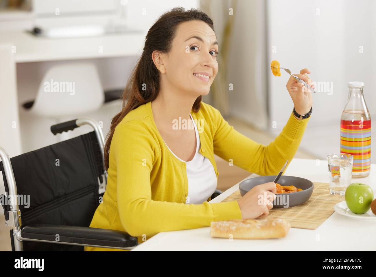 beautiful disabled woman having lunch Stock Photo - Alamy
