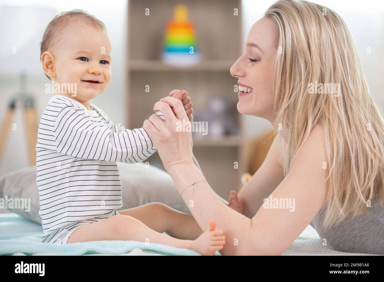 mom taking care of her newborn baby in the morning Stock Photo - Alamy