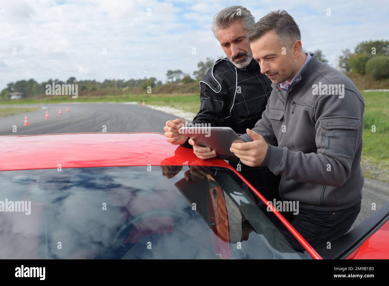 a racing driver checking race Stock Photo - Alamy