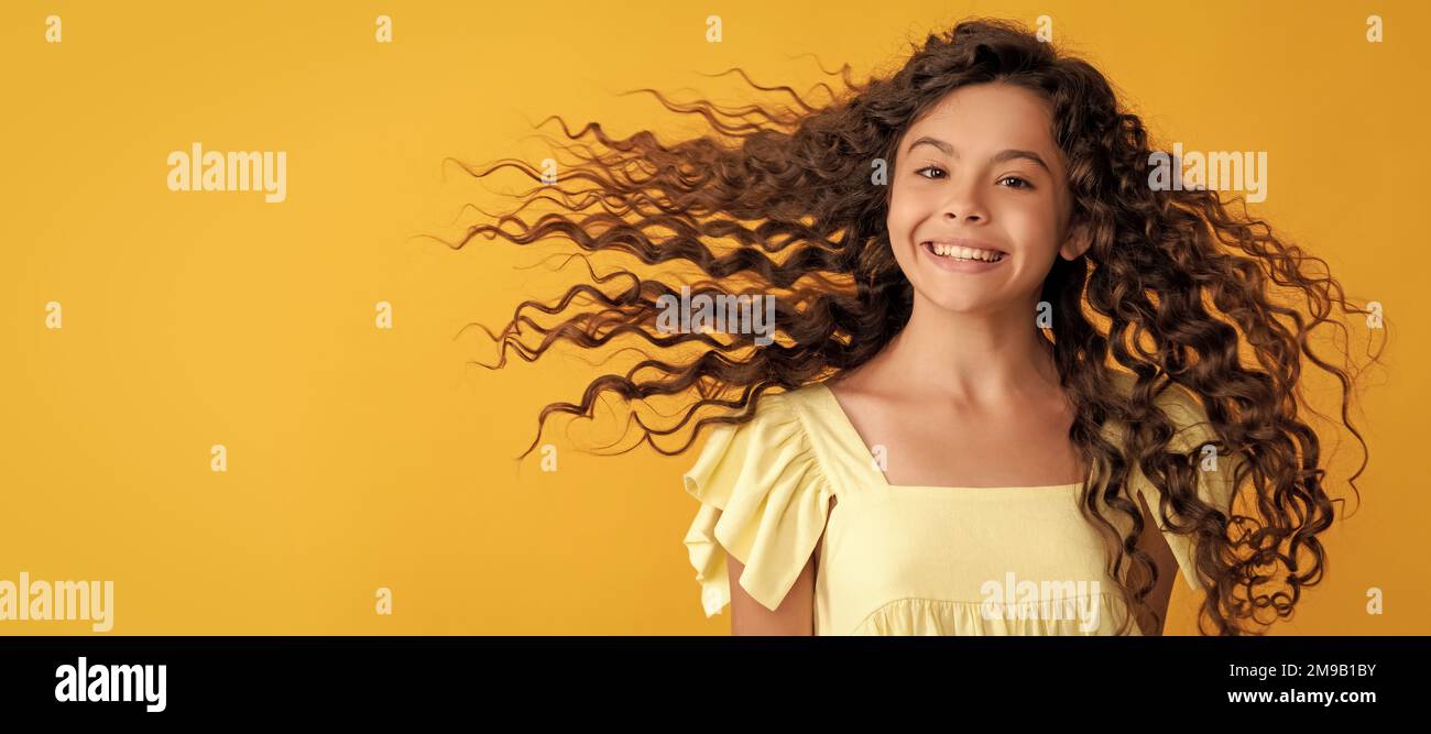 happy kid with long curly hair and perfect skin, volume hair. Child ...
