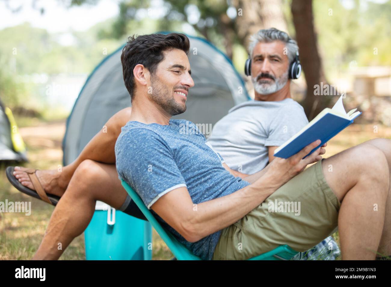 2 male friends camping and relaxing Stock Photo - Alamy