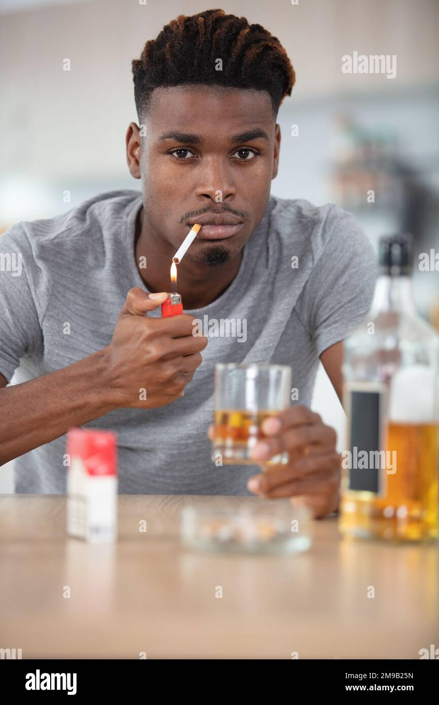 Man drinking beer smoking cigarette hi-res stock photography and images ...