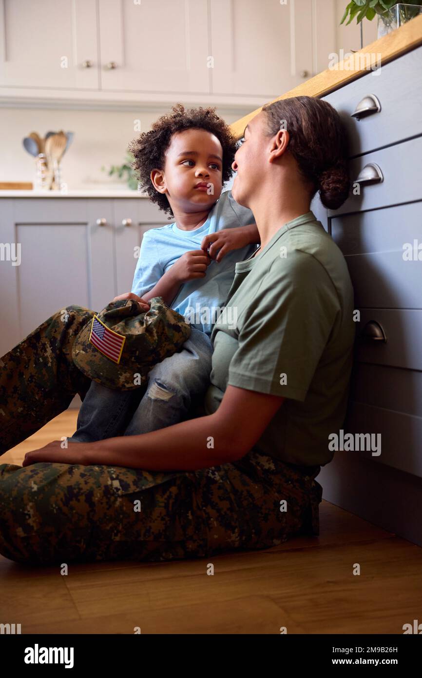 American Army Mother In Uniform Home On Leave Hugging Son Sitting On ...