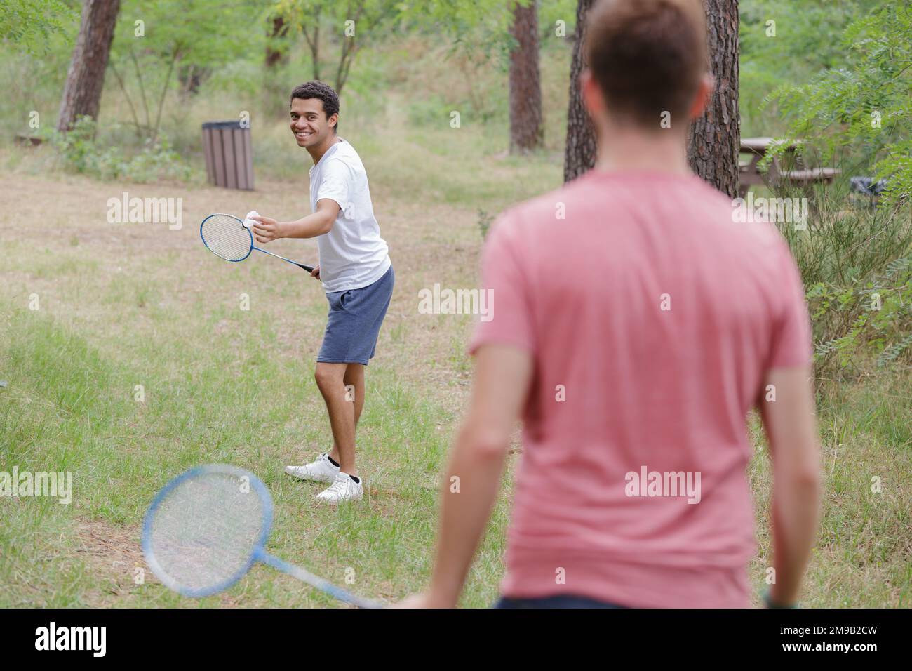 young people playing badminton outdoors Stock Photo - Alamy