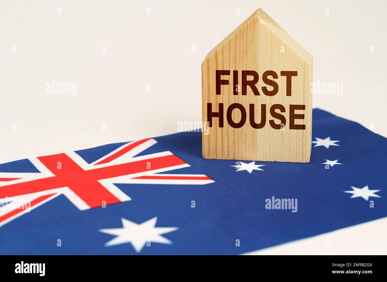 Real estate concept. On the flag of Australia there is a model of a ...