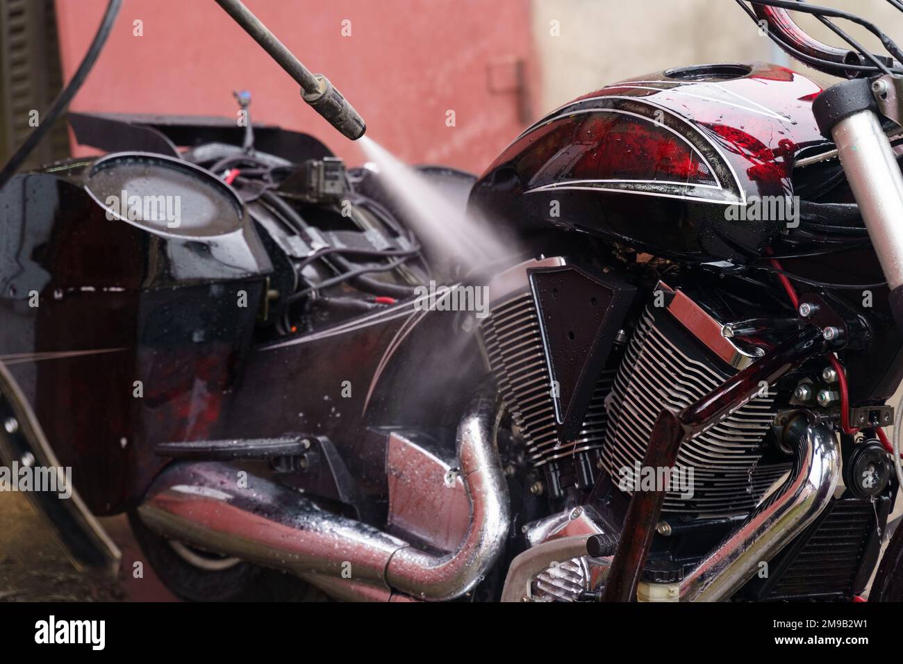 Washing a motorcycle engine with a high pressure jet. Close-up Stock ...