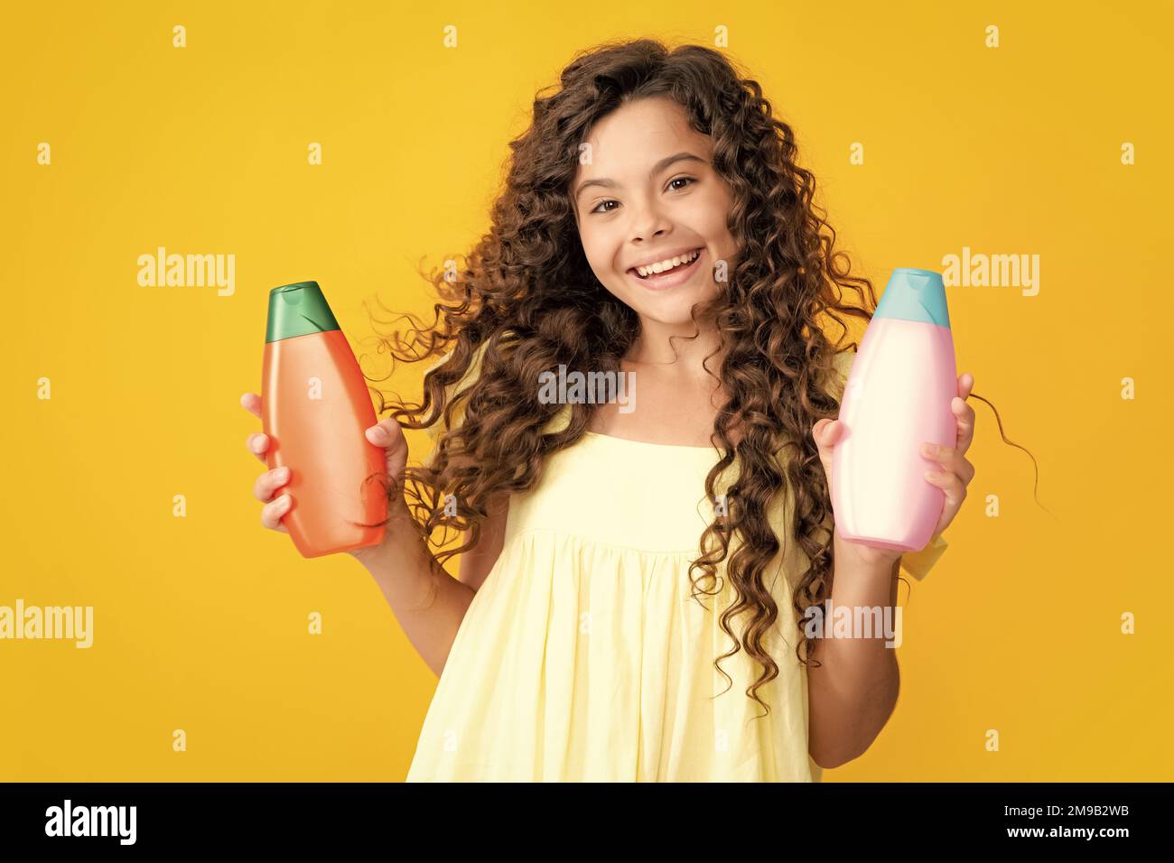 Teenage girl with shampoos conditioners or shower gel. Kids hair care ...