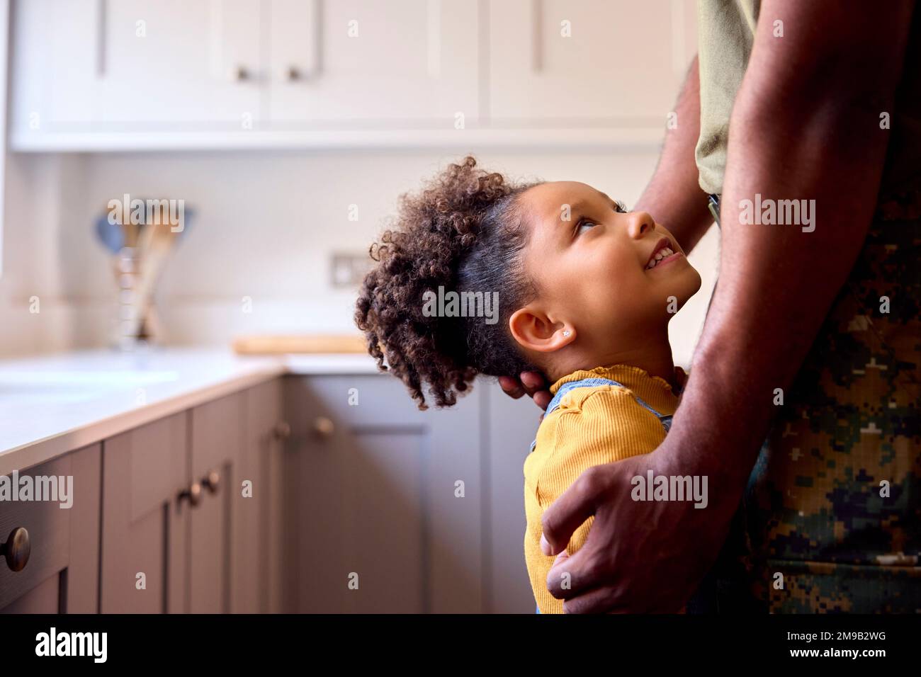 Close Up Of Loving Army Father In Uniform Home On Leave Hugging ...