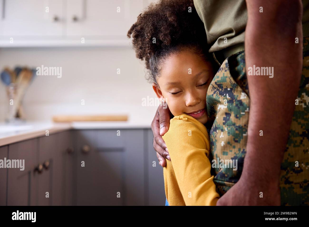 Close Up Of Loving Army Father In Uniform Home On Leave Hugging ...