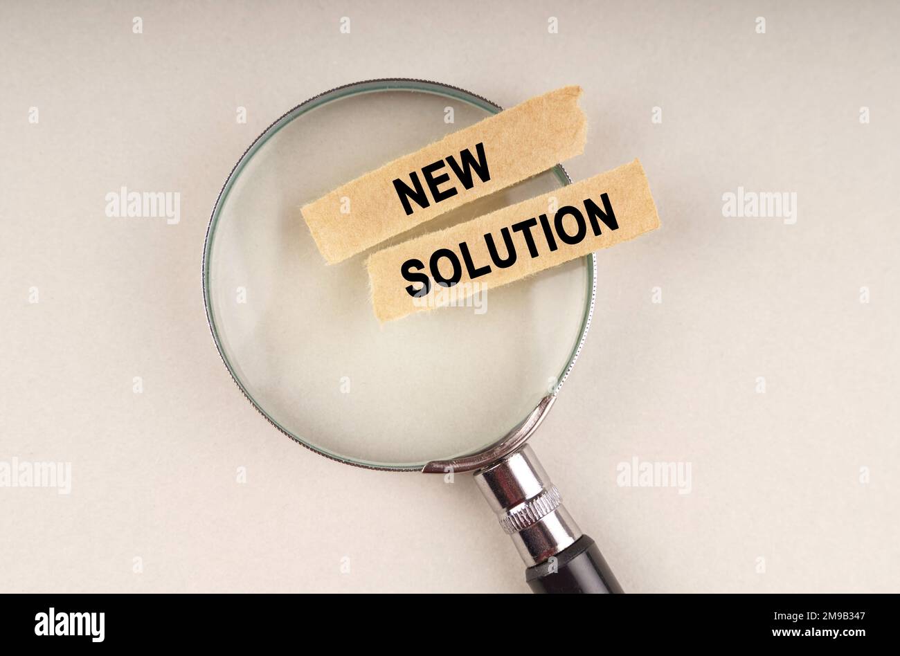On the magnifying glass are paper strips with the inscription - NEW ...
