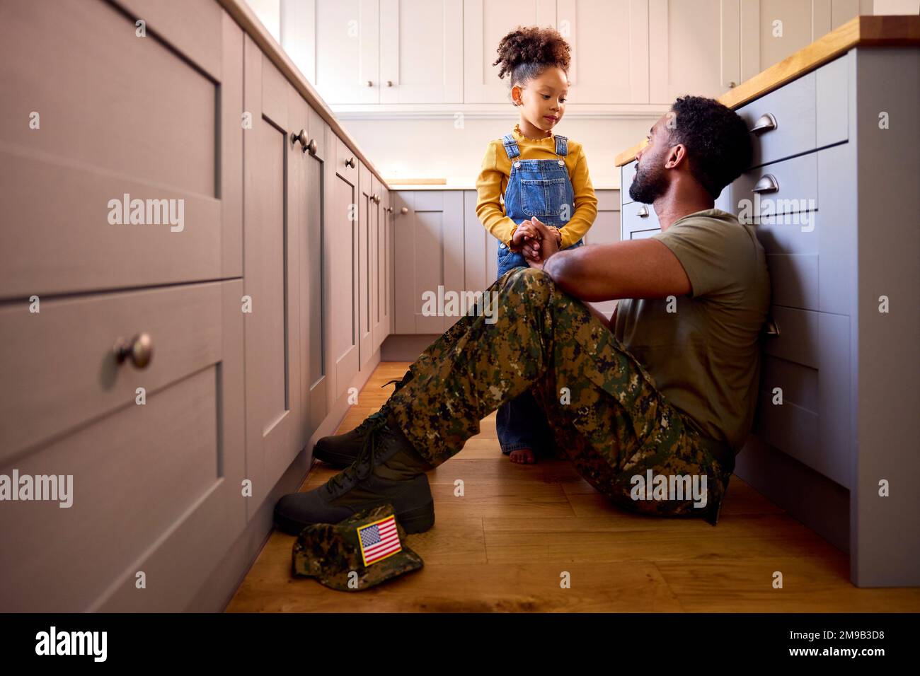 Daughter Comforting Depressed Father In Uniform Suffering With PTSD ...