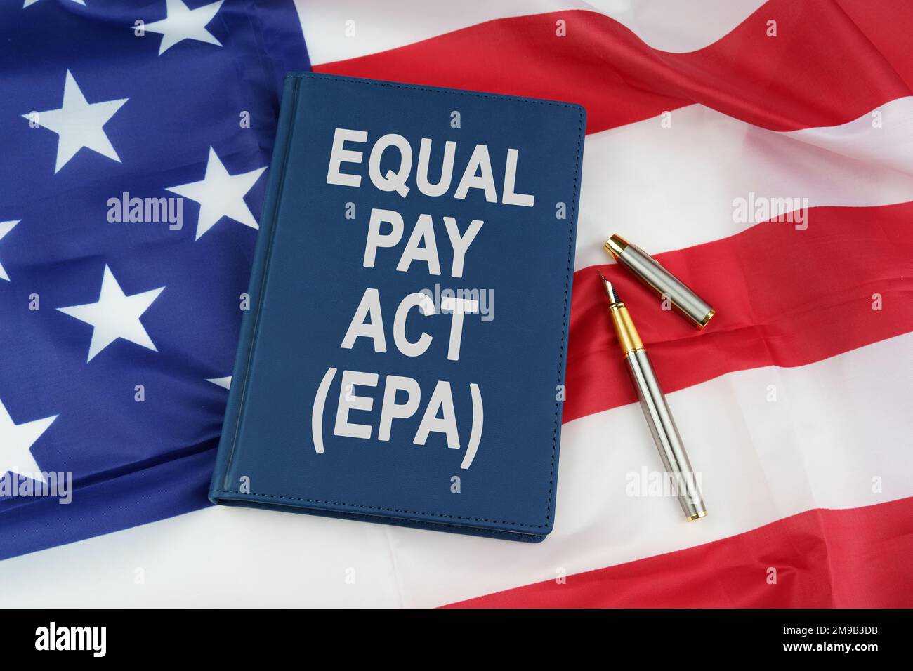 Law concept. On the US flag lies a pen and a book with the inscription ...