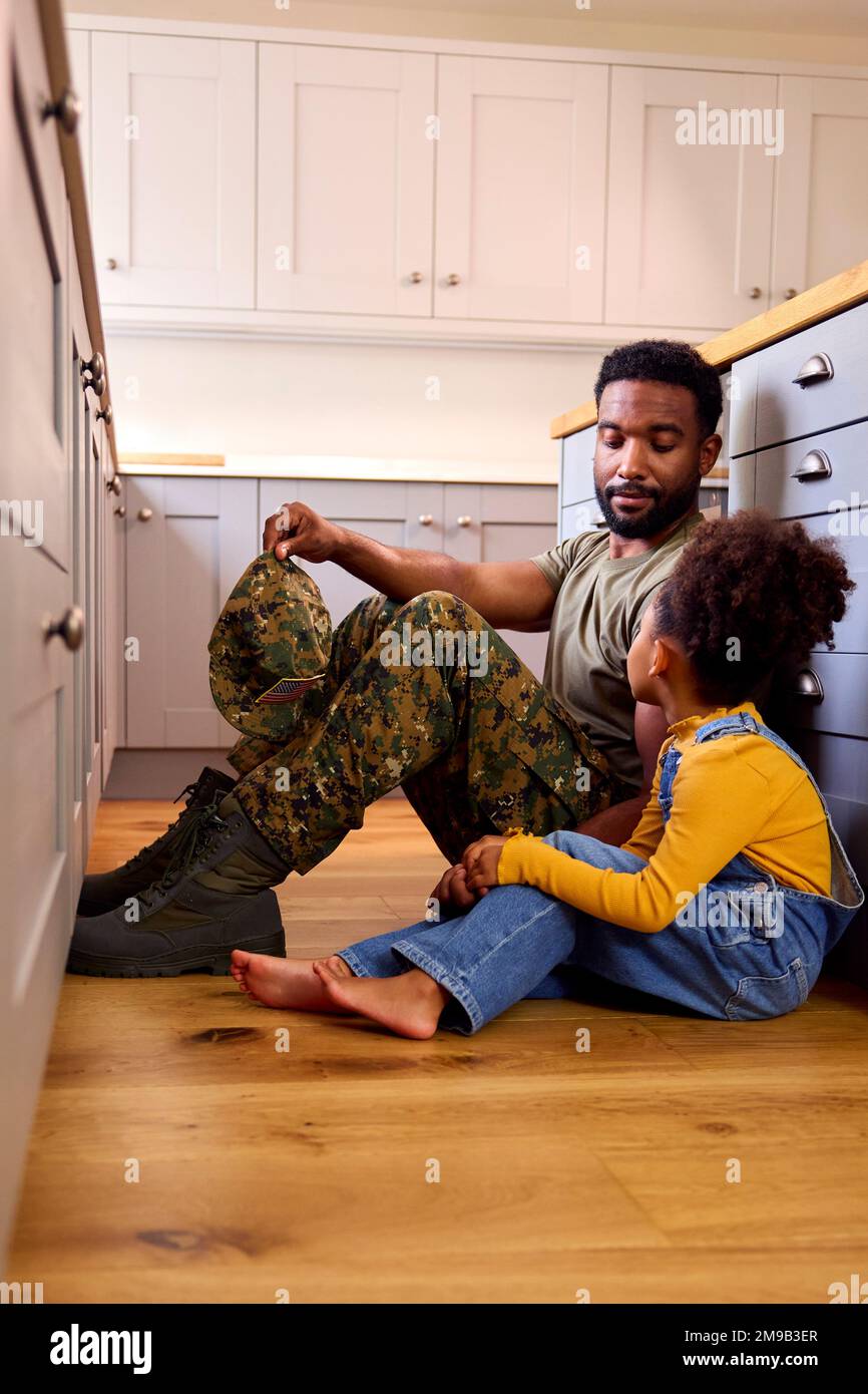 Daughter Comforting Depressed Father In Uniform Suffering With PTSD ...
