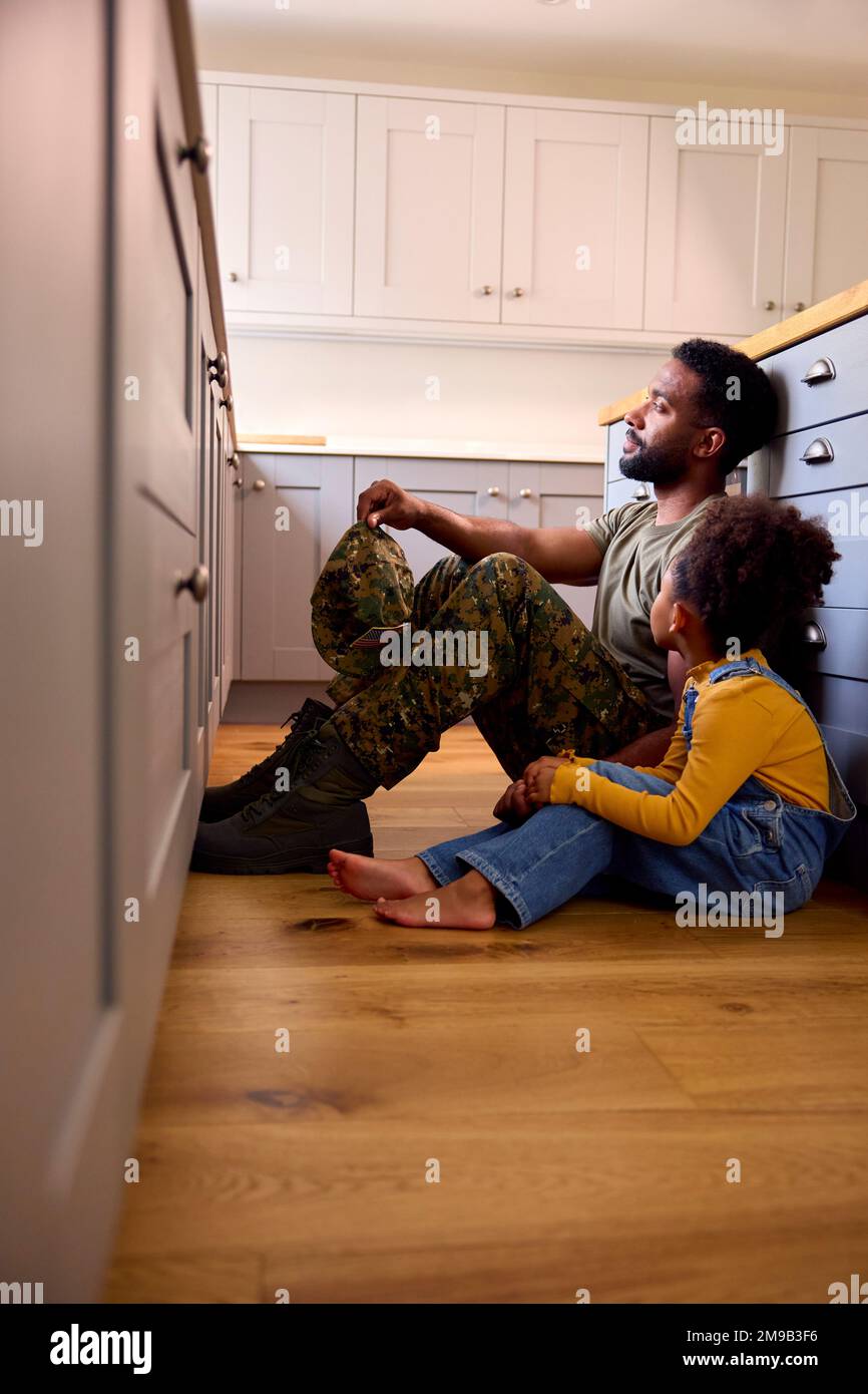 Daughter Comforting Depressed Father In Uniform Suffering With PTSD ...