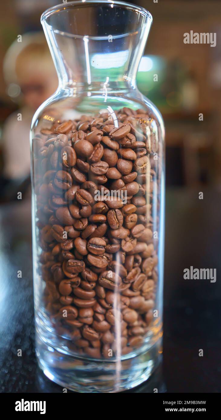 A closeup shot of coffee beans in a glass bottle Stock Photo - Alamy