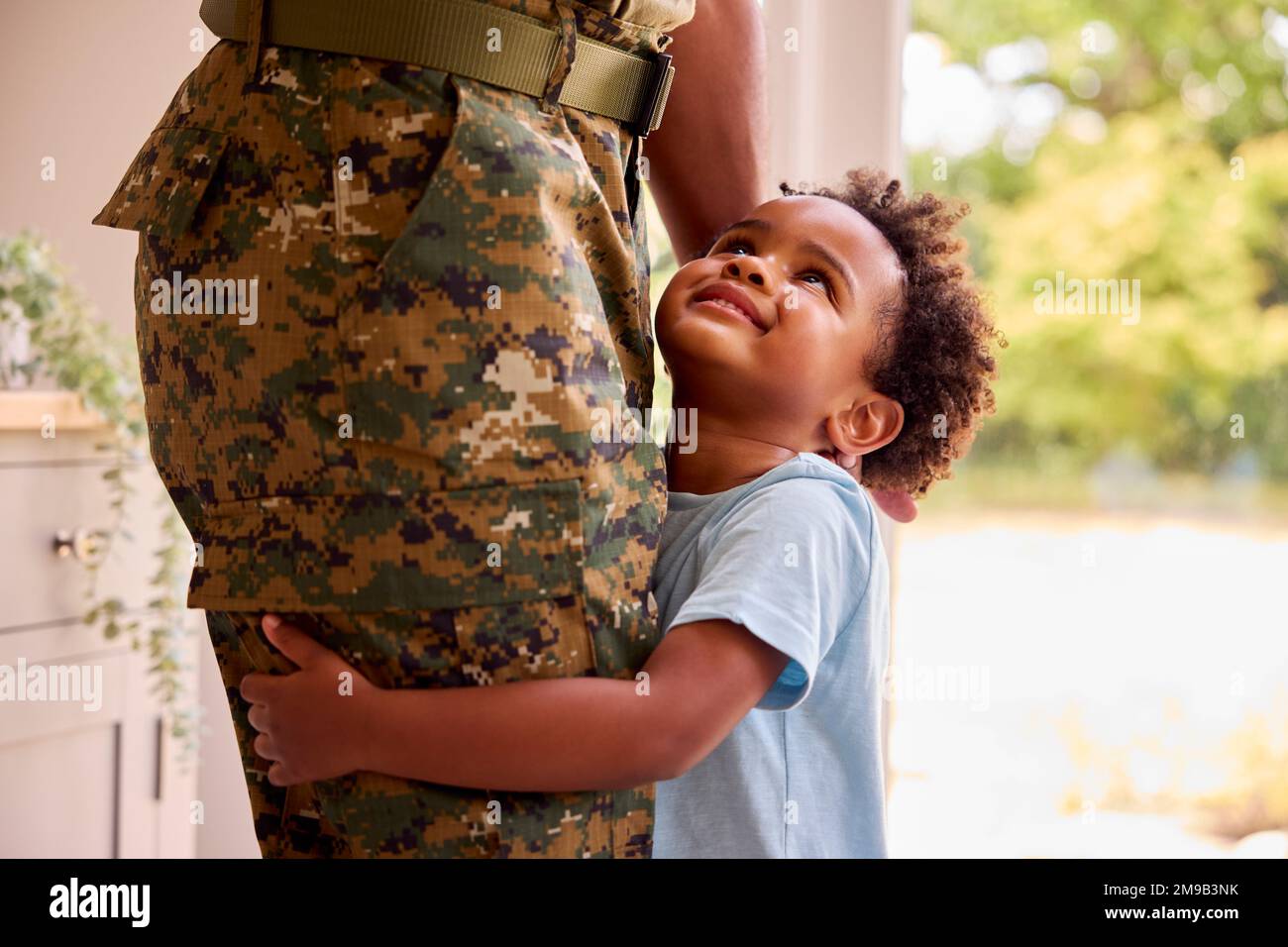 Close Up Of Loving Son Hugging Army Father In Uniform Home On Leave Stock Photo - Alamy