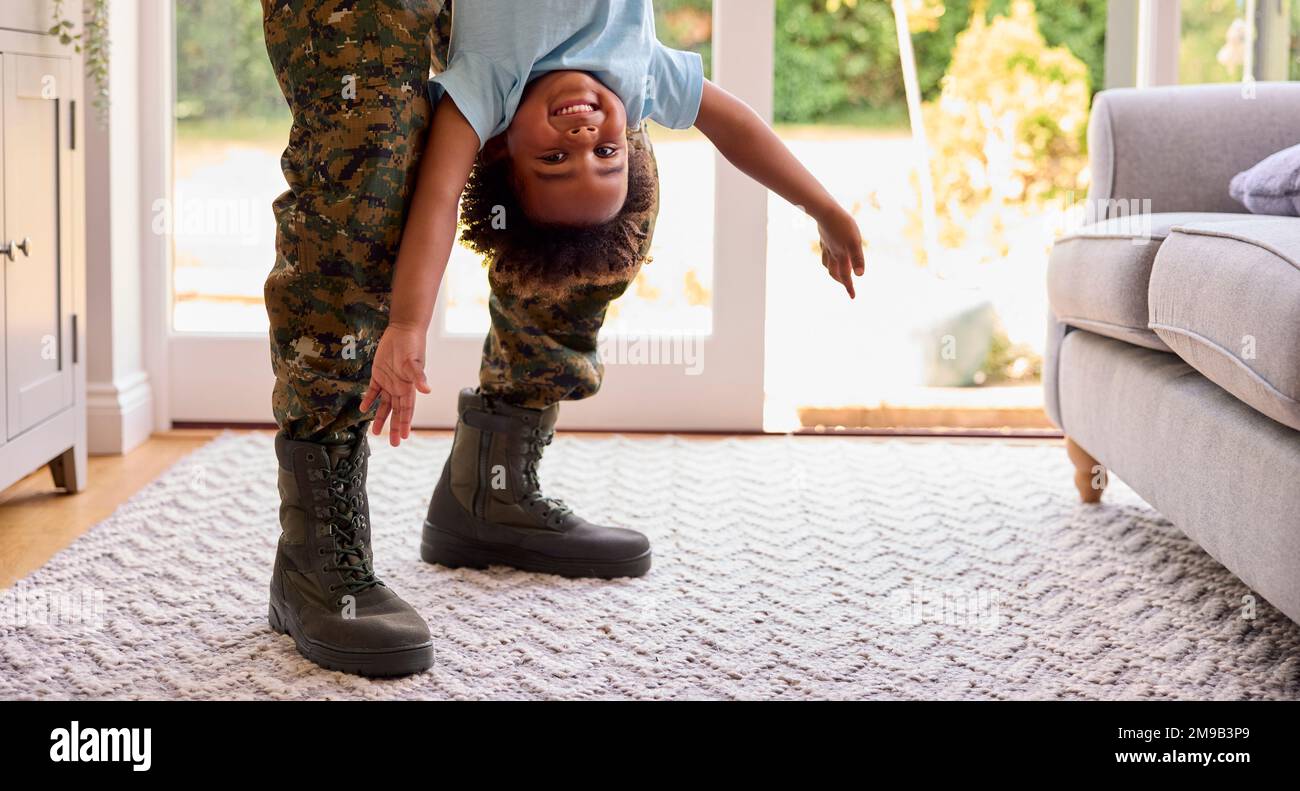 Close Up Of Loving Army Father In Uniform Home On Leave Holding Son ...