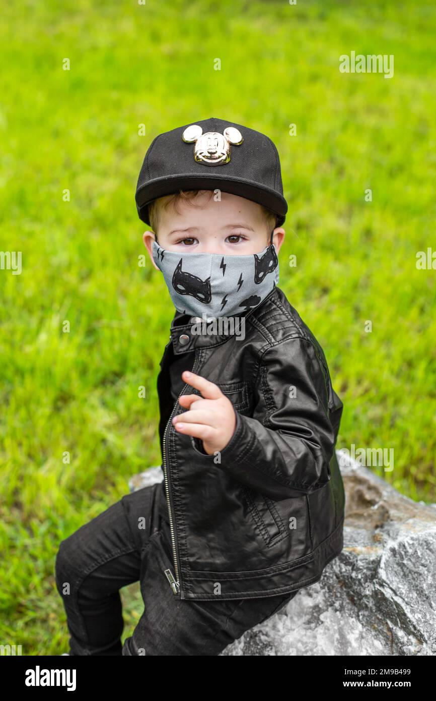 Boy in the spring park with blossom tree Stock Photo - Alamy