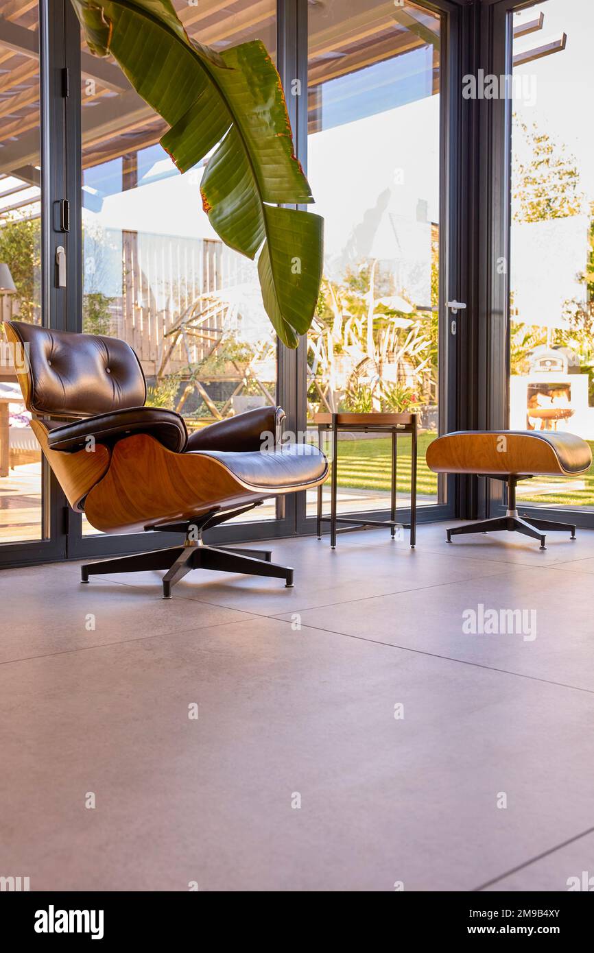 Glass Walled Room Looking Out Onto Outdoor Seating And Garden In Modern ...