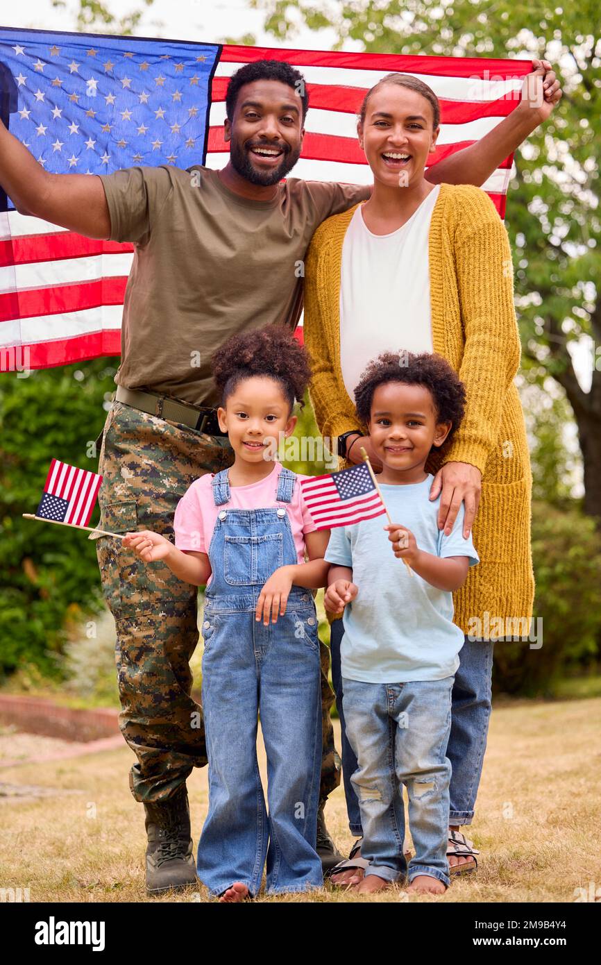 Portrait Of American Army Family Outdoors In Garden Holding Stars And ...
