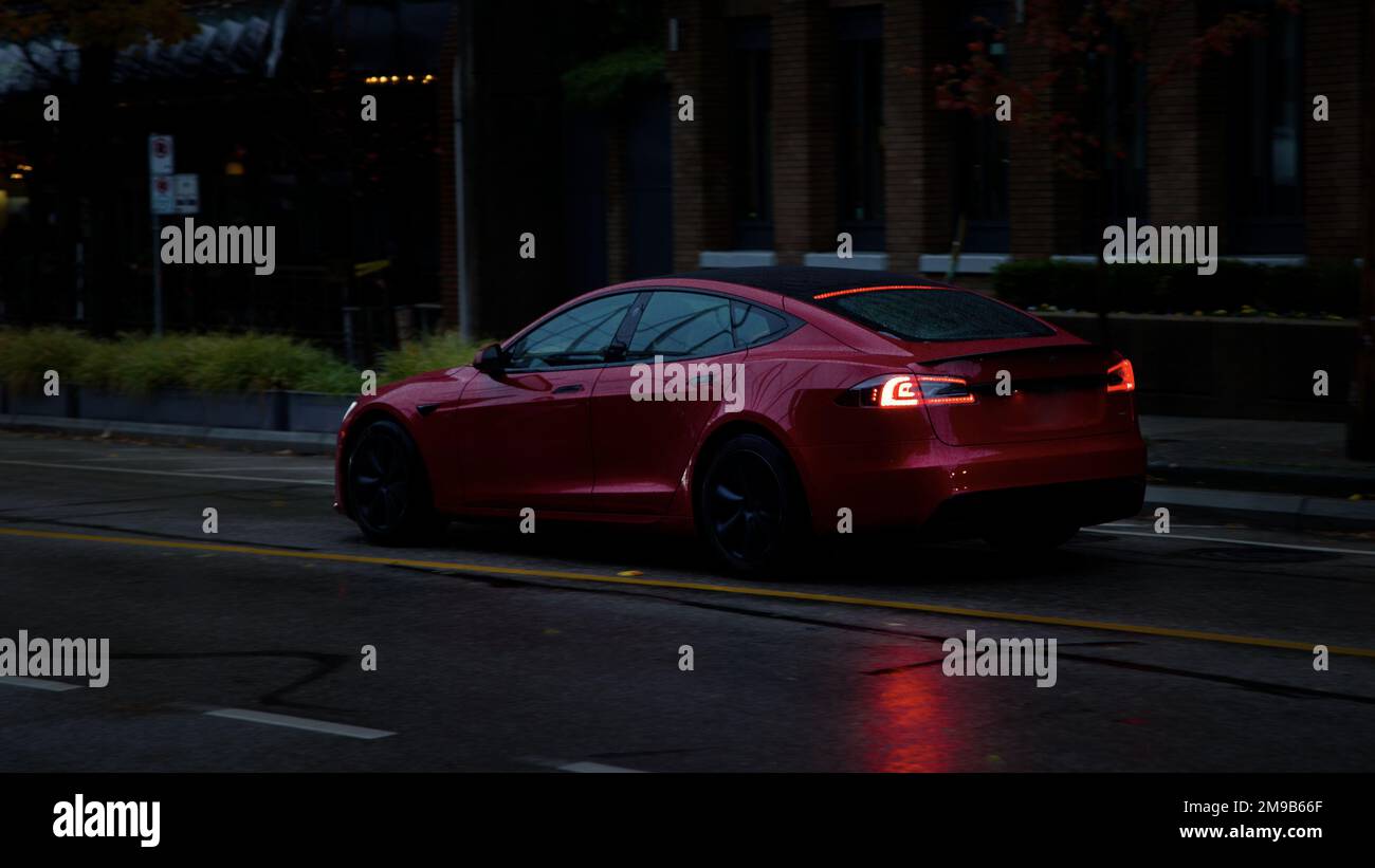 A red big Ford Mustang car driving at high speed on the road in the ...