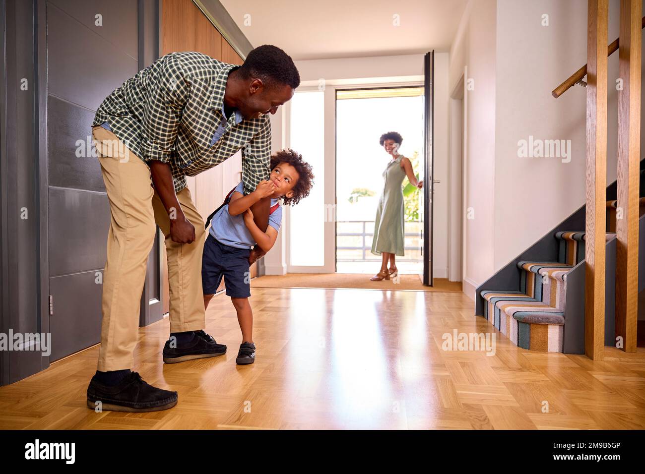 Parents At Home Helping Son Getting Ready To Go To School Stock Photo ...