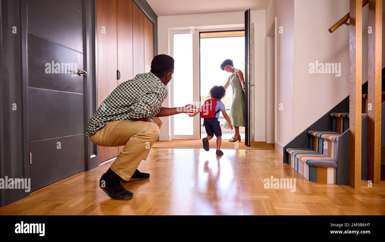 Parents At Home Helping Son Getting Ready To Go To School Stock Photo ...