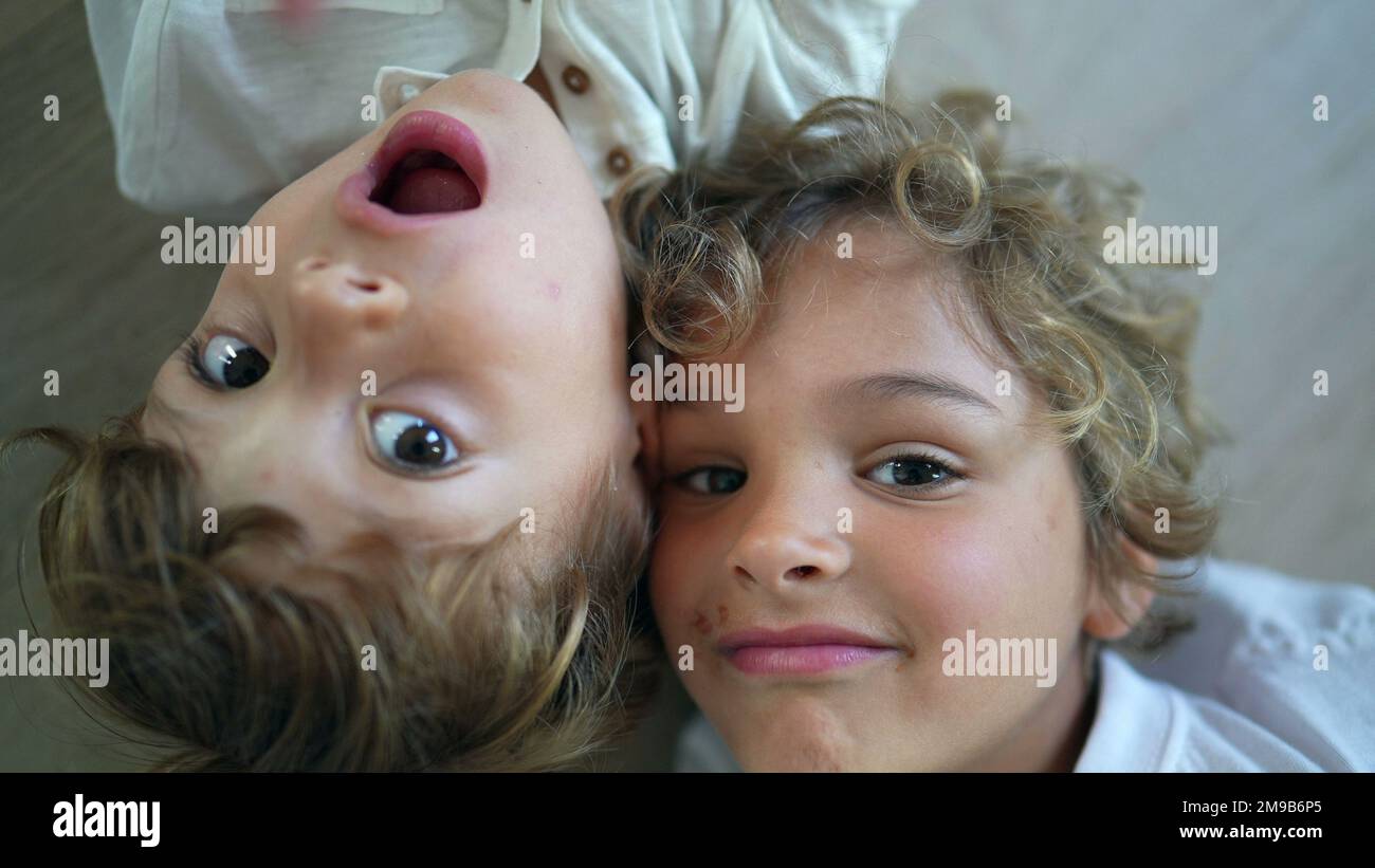Two handsome little kids lying on floor together, blond children Stock ...