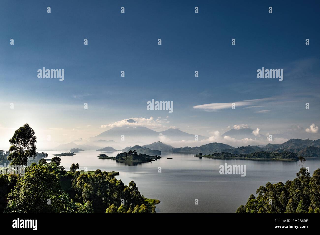 Lake Mutanda in the south west of Uganda with the Virunga Volcanoes of ...