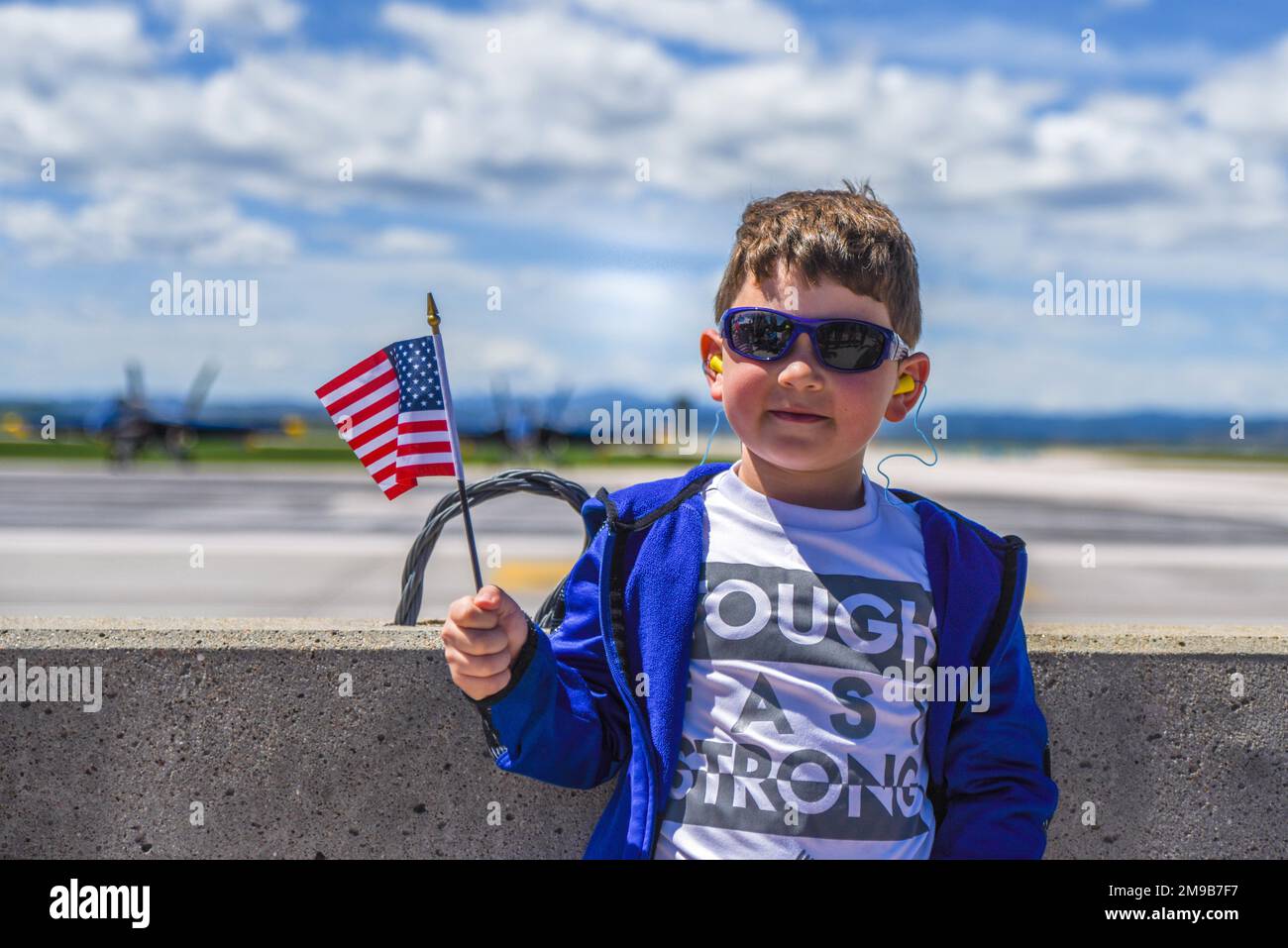 5 year-old Koltyn Usera waves an American flag as he waits for the ...
