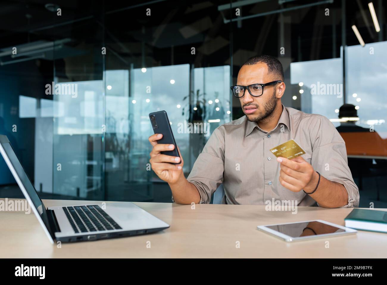 Dissatisfied and angry businessman in office trying to make purchase in ...