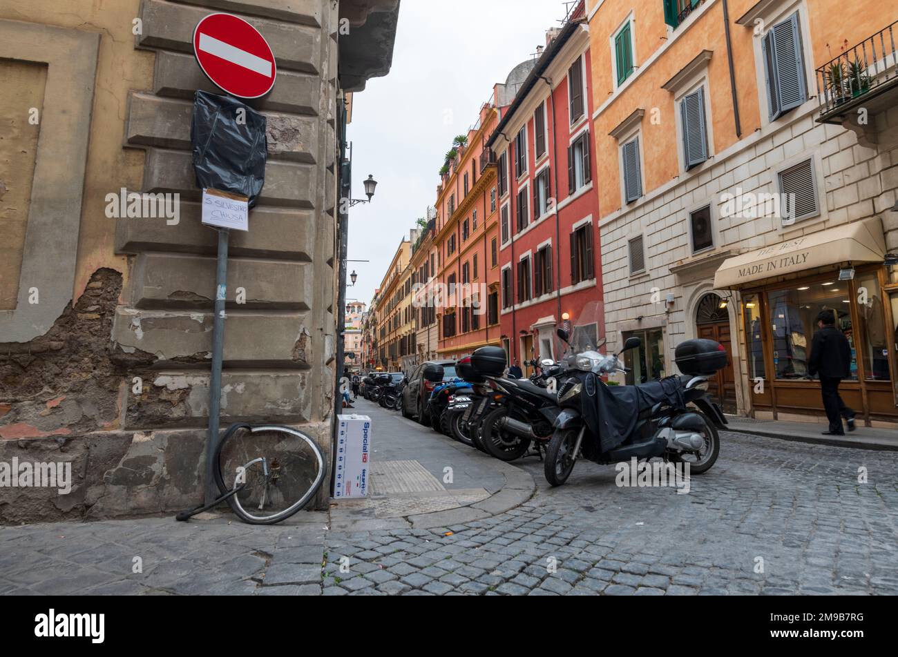 Do Not Enter street sign and a broken wheel of a stolen bicycle chained ...