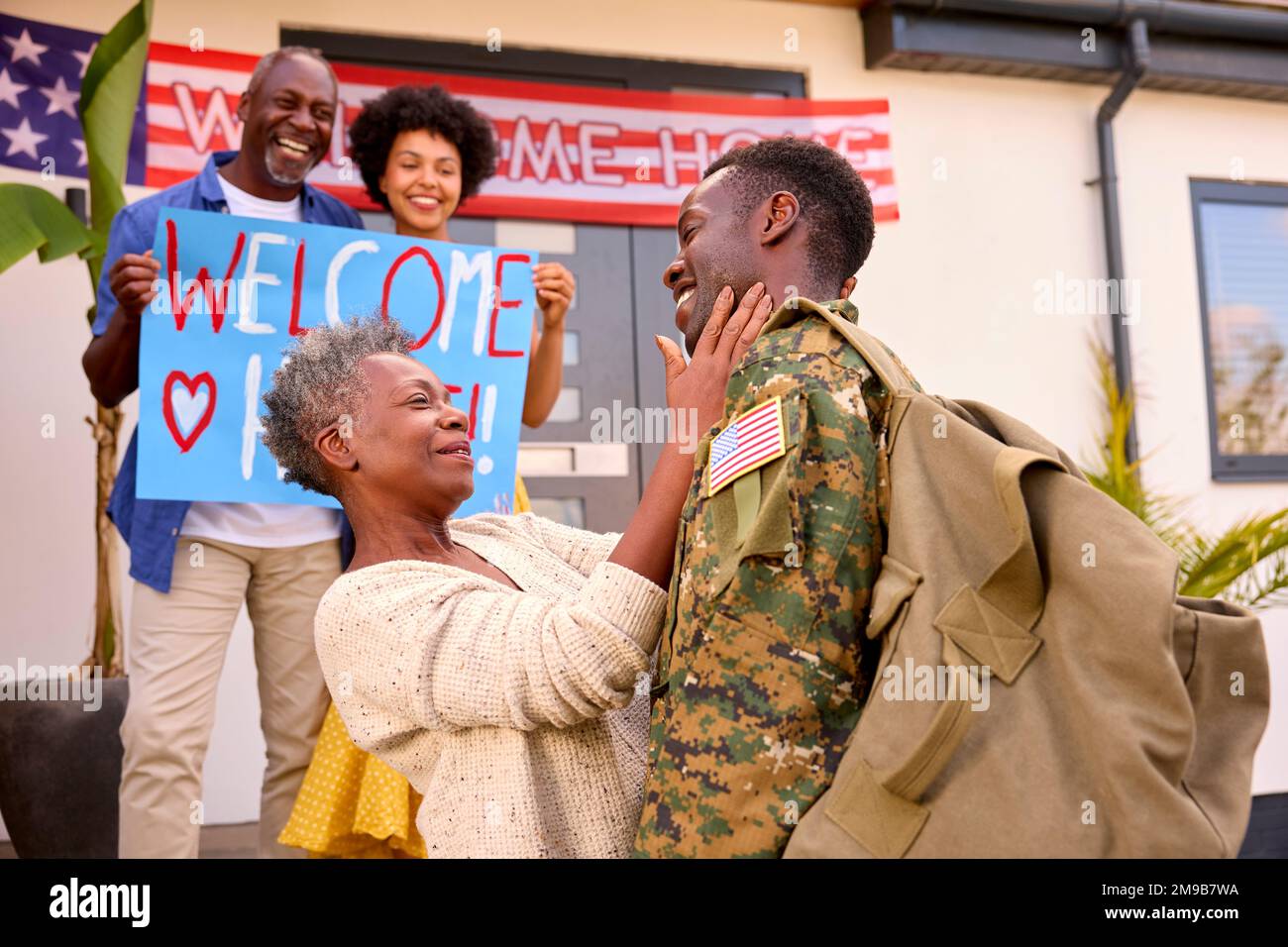 Multi-Generation Family With Parents And Wife Welcoming Army Soldier ...