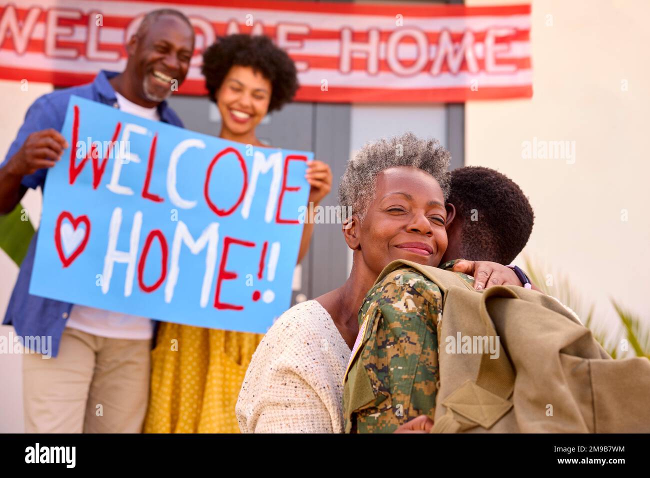 Multi-Generation Family With Parents And Wife Welcoming Army Soldier ...