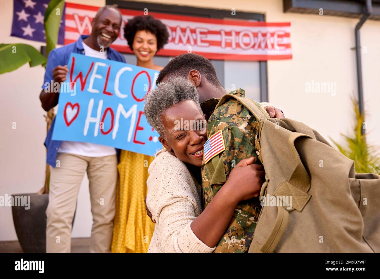 Multi-Generation Family With Parents And Wife Welcoming Army Soldier ...