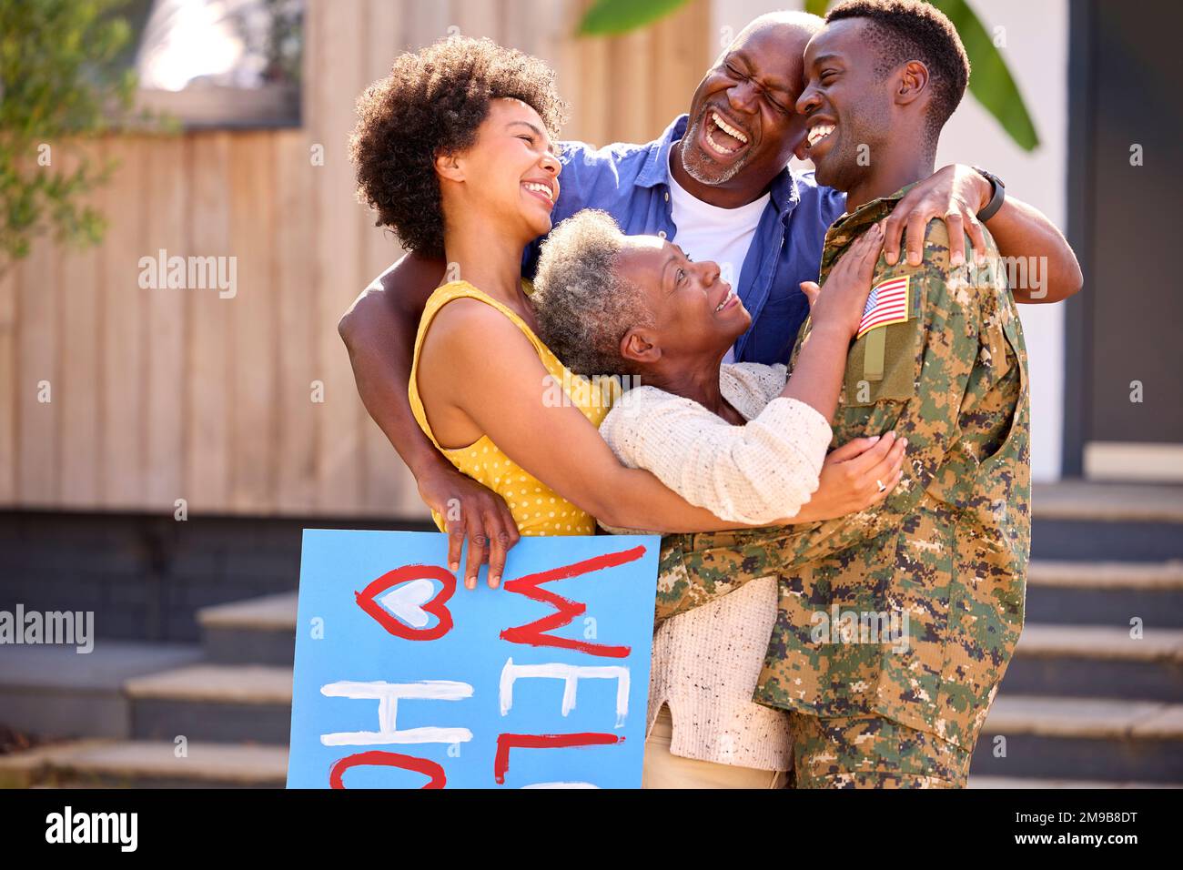 Multi-Generation Family With Parents And Wife Welcoming Army Soldier ...