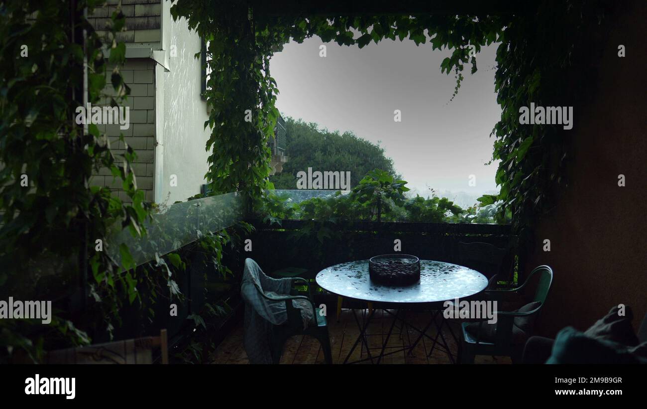 Rainy day home balcony exterior with falling rain Stock Photo - Alamy