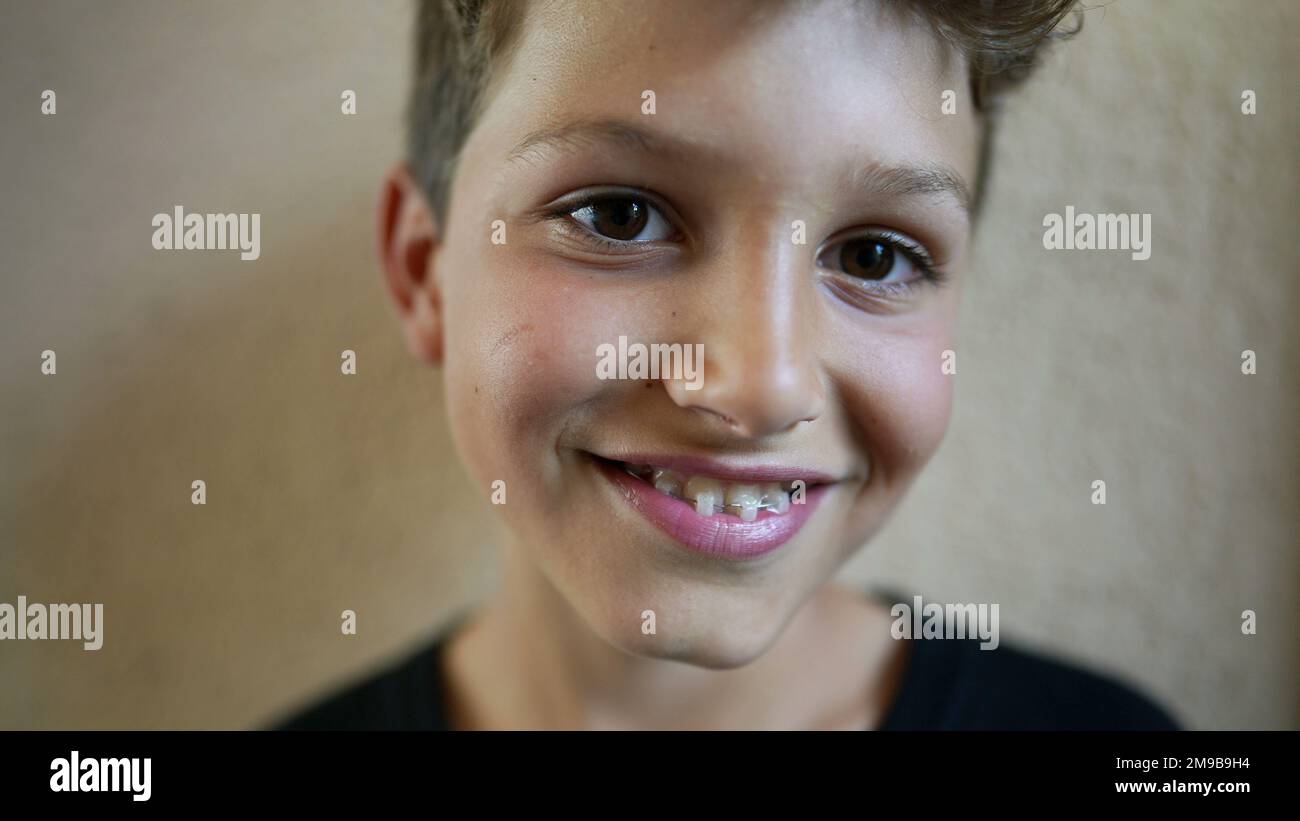 Portrait young boy child smiling at camera. Close-up kid face looking ...
