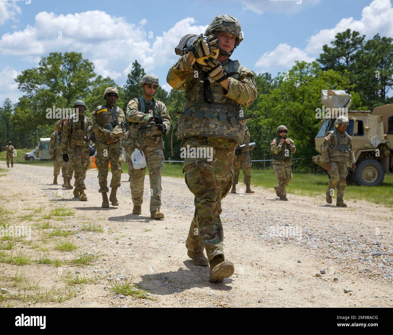 Soldiers with the 61st Troop Command carry explosives to the demolition ...