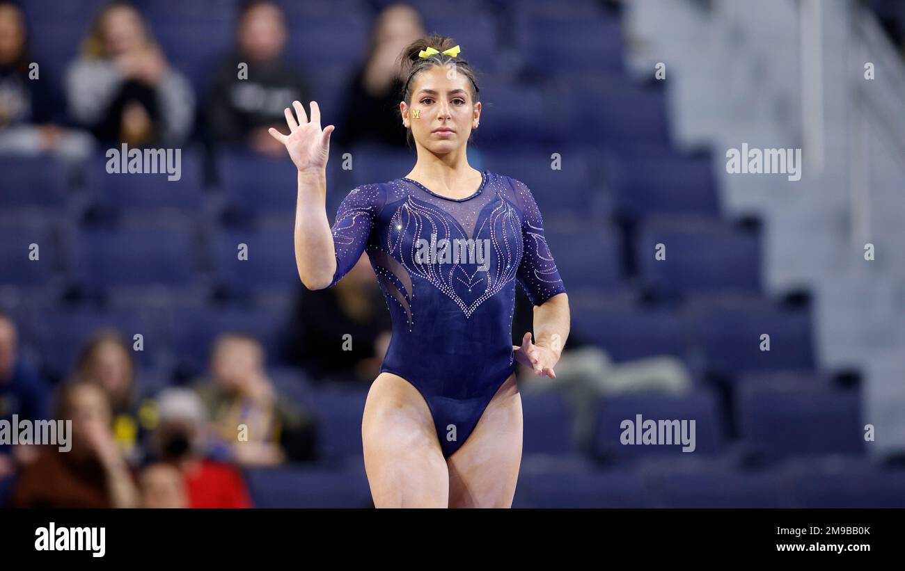 Michigan's Nicoletta Koulos competes in the beam during an NCAA ...
