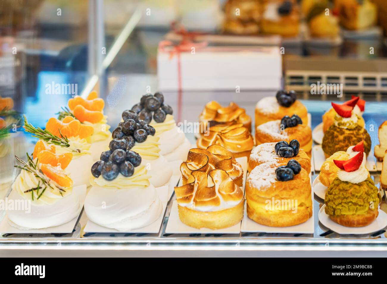 Assortment of different desserts, cakes on cafe showcase. Various ...