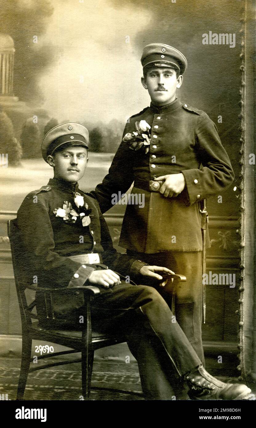 Two German soldiers in studio photo with roses pinned to their uniforms ...