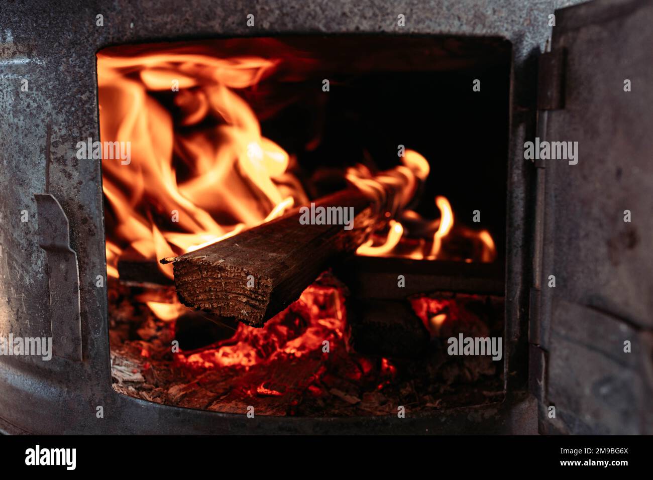 Close-up of a wood stove burning fire Stock Photo - Alamy