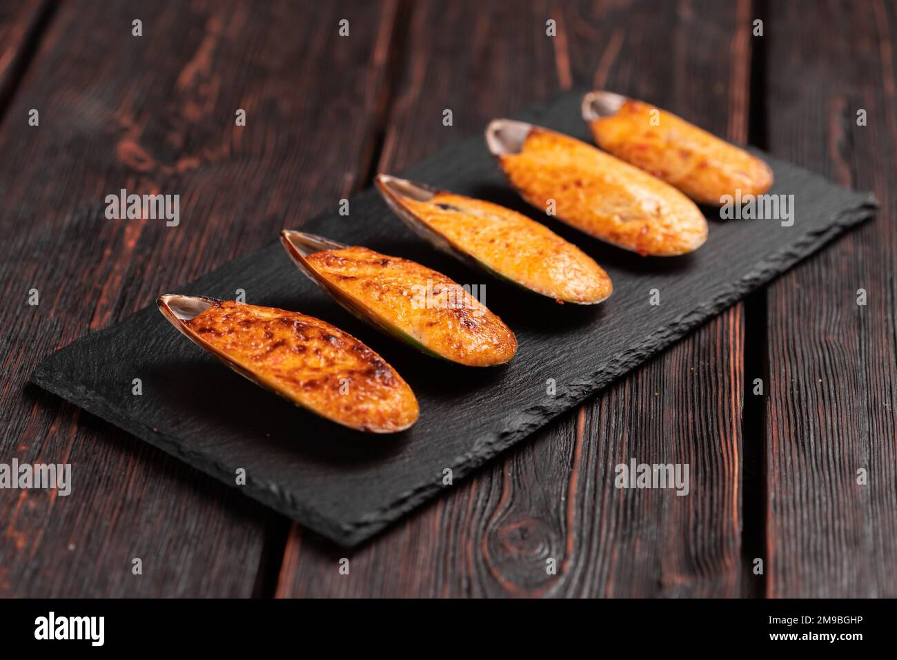 Baked mussels with cheese sesame seeds in shells - asian food Stock ...