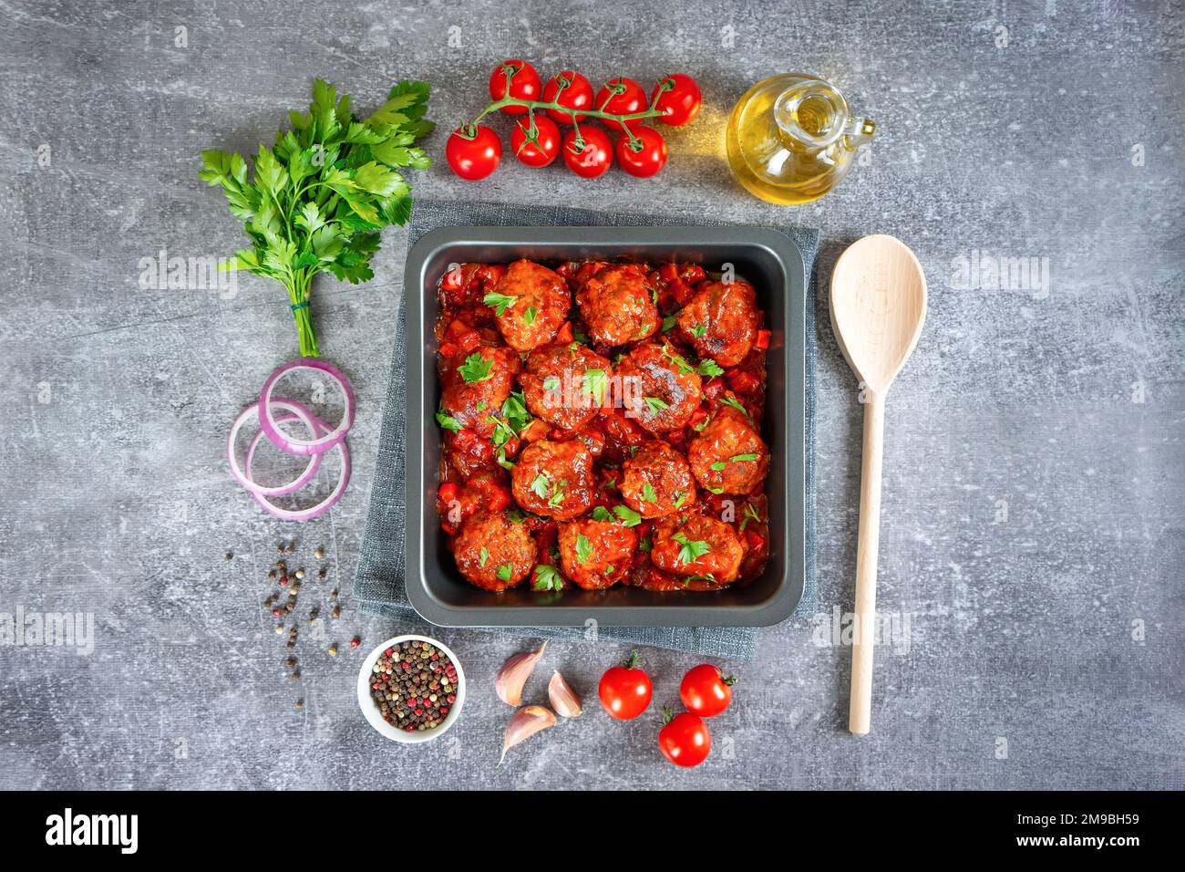 Homemade meatballs with tomato sauce and spices served in black pan on ...