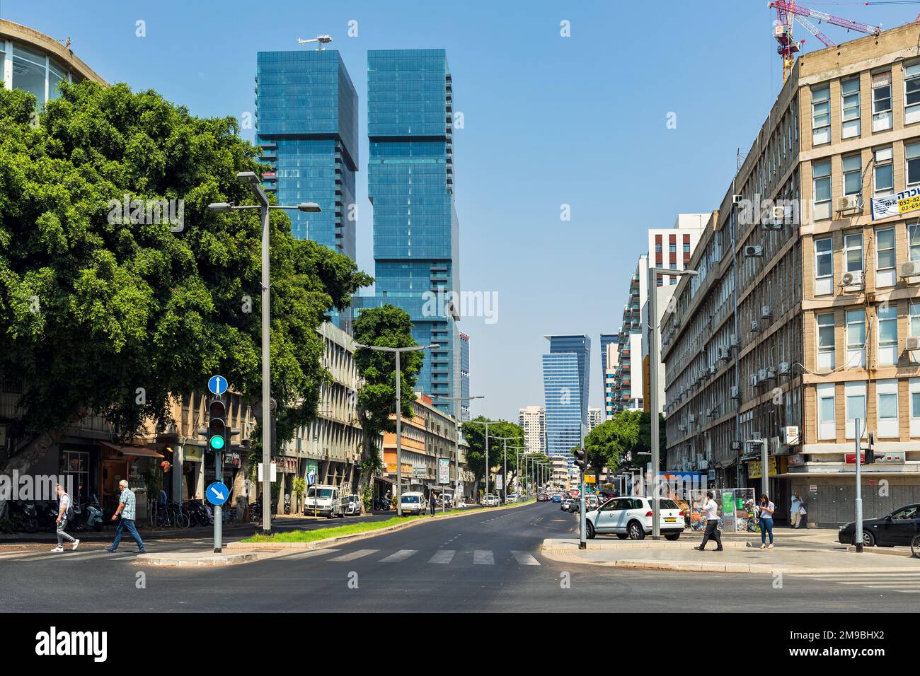 People walking in the city center with old buildings and modern ...