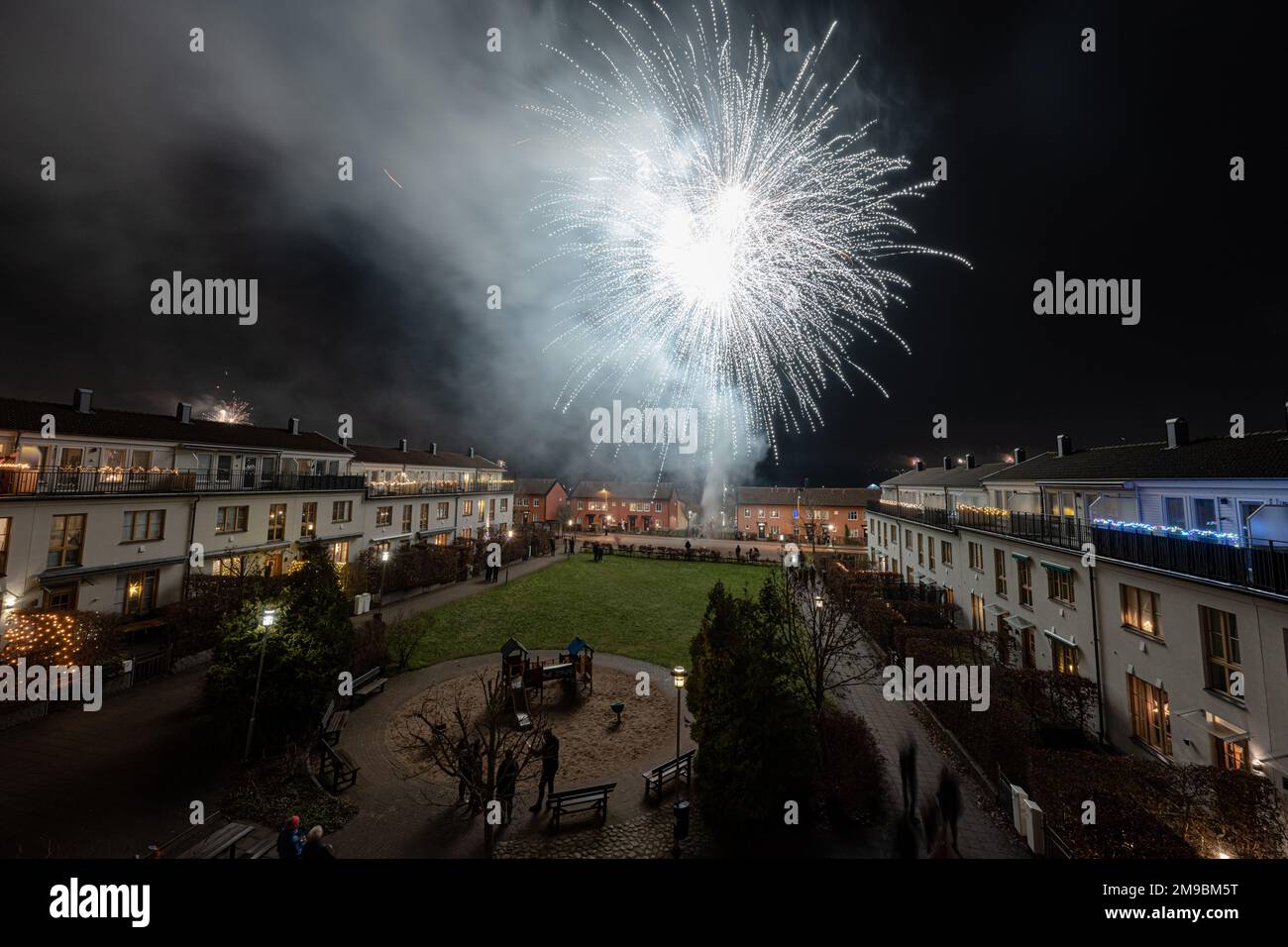 Fireworks launched between rows of houses Stock Photo - Alamy