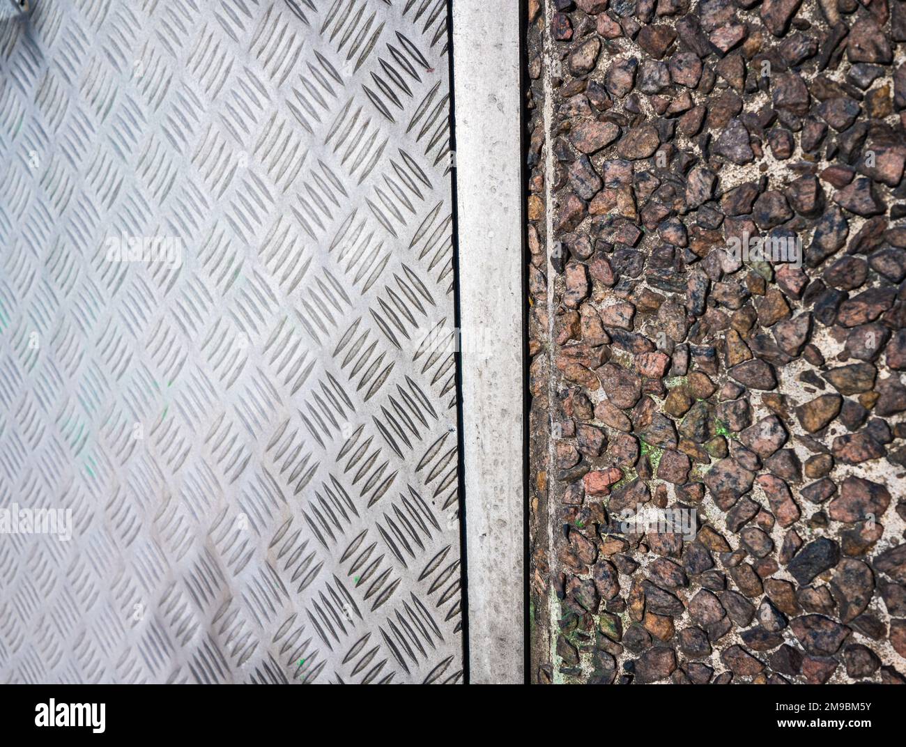 Detail of a stone pebble wall and aluminium plate Stock Photo - Alamy