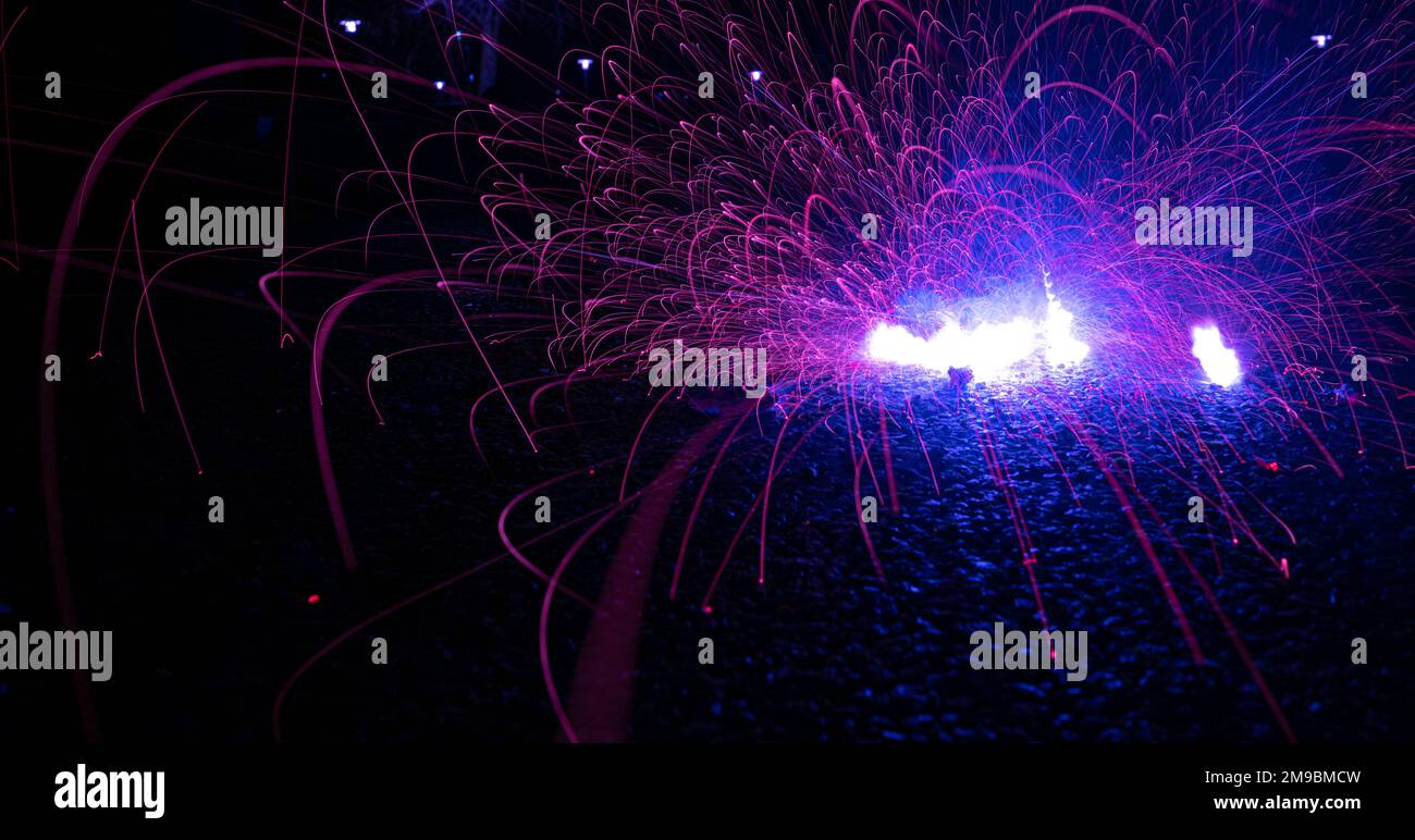 Purple ground fireworks on asphalt Stock Photo - Alamy