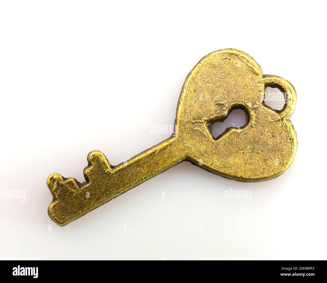 metallic brass key with the symbol of a heart symbol of lovers and ...